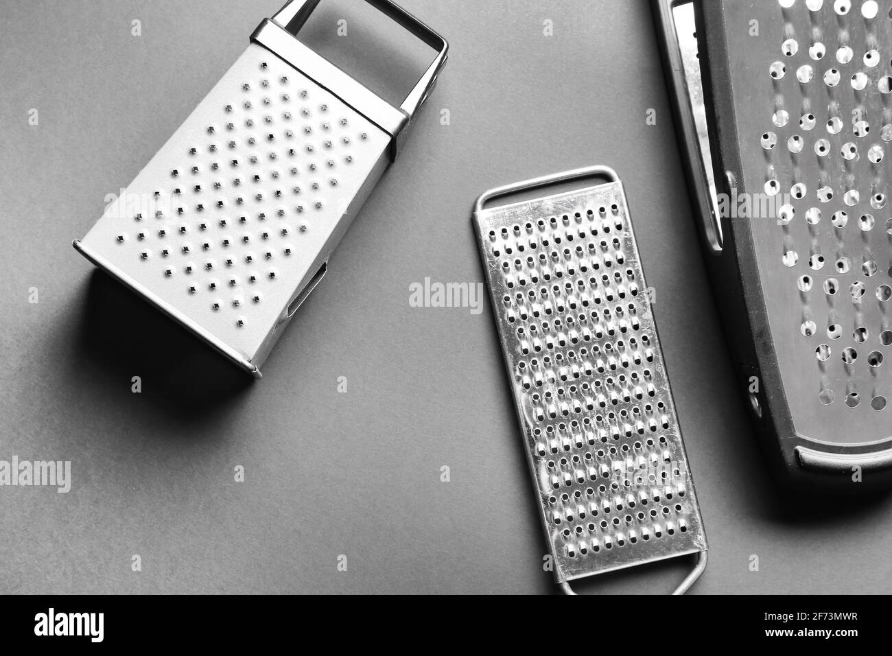 Different graters on dark background Stock Photo - Alamy