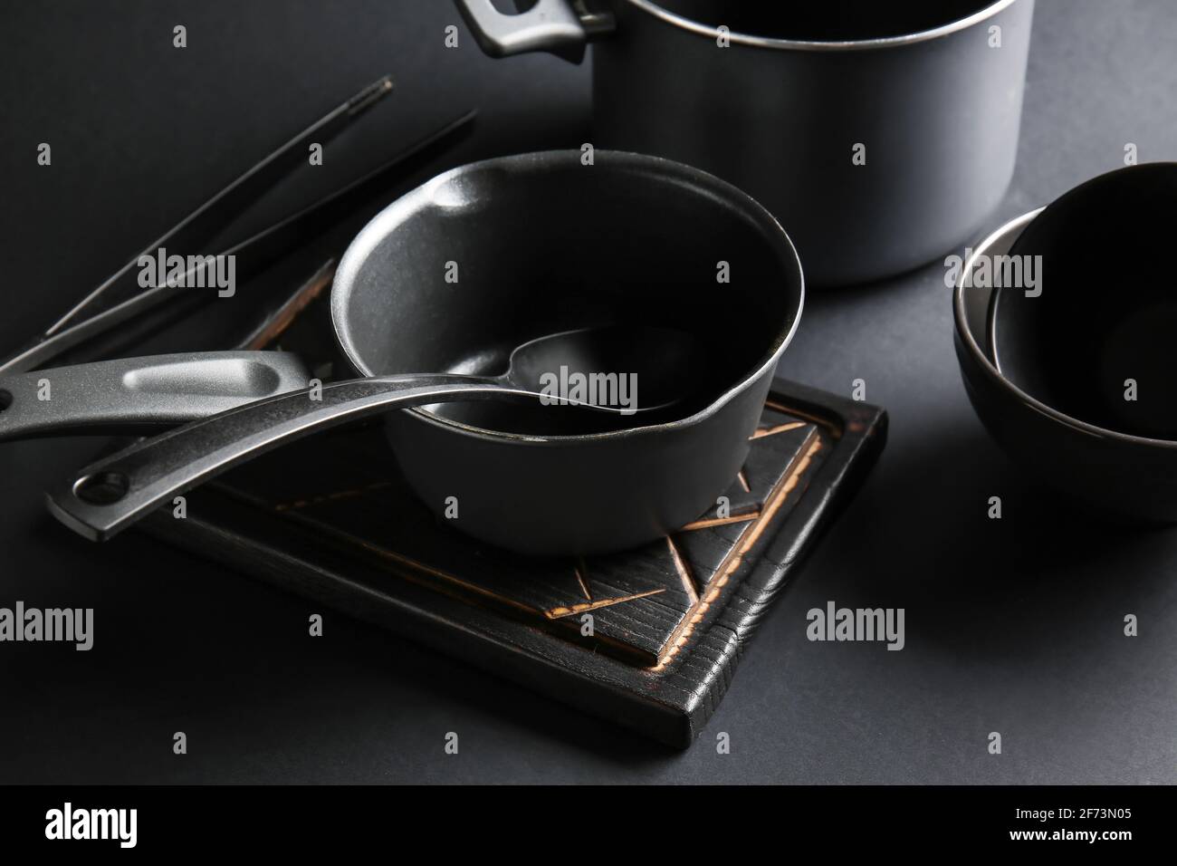 Cooking pots on dark background Stock Photo - Alamy