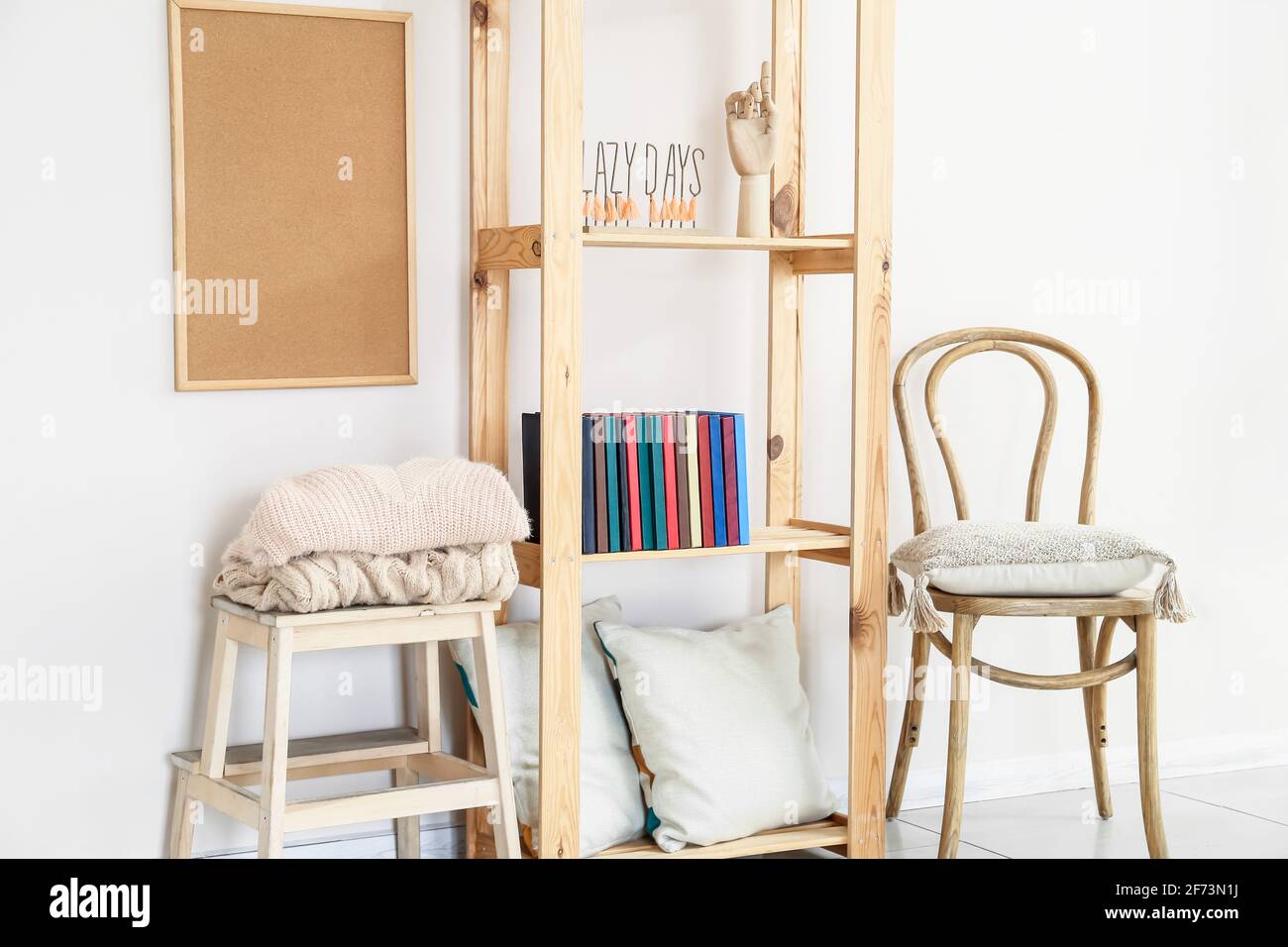 Interior of modern room with shelf unit and chair Stock Photo - Alamy