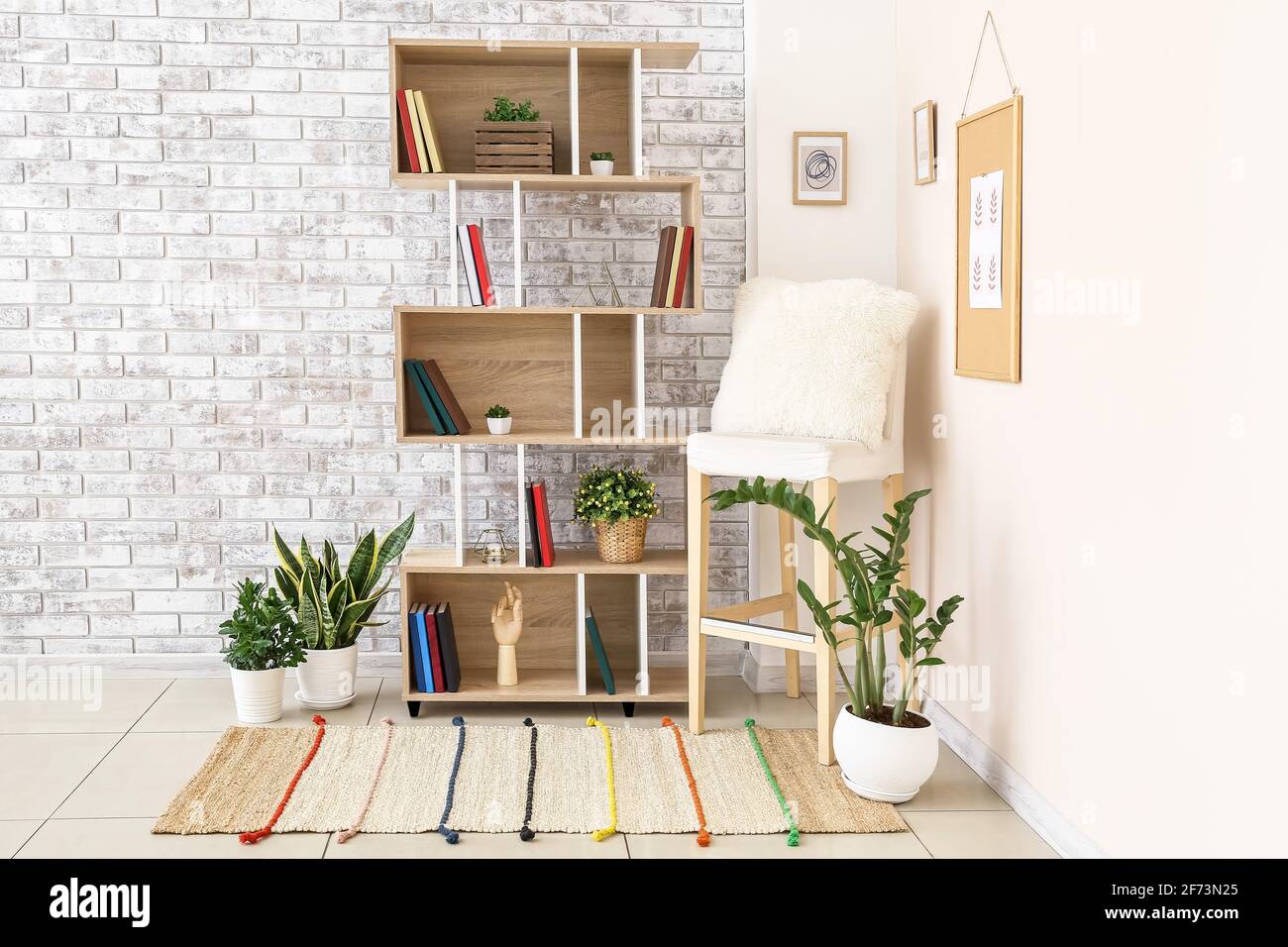 Interior of modern room with shelf unit and chair Stock Photo - Alamy