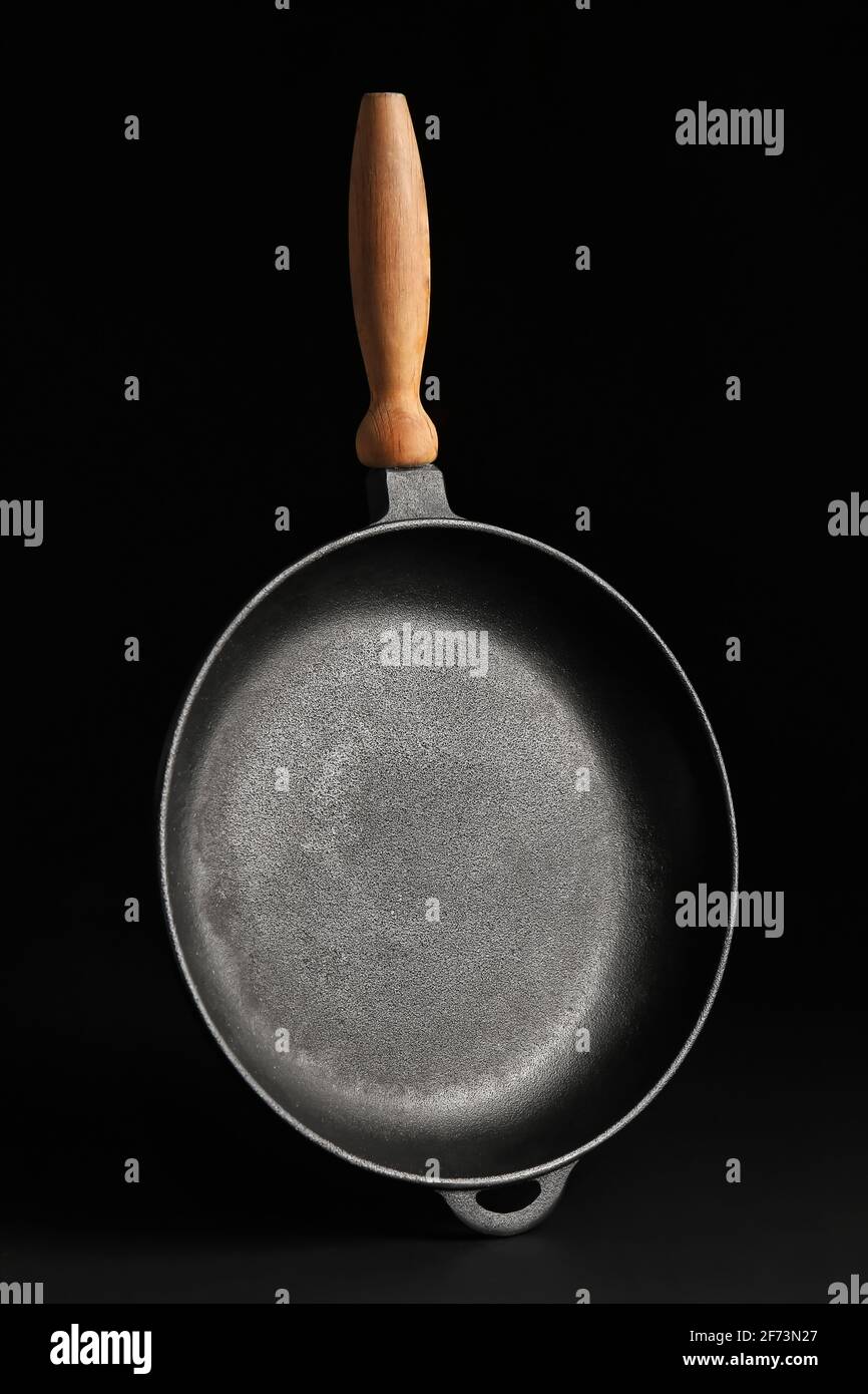 Frying pan on dark background Stock Photo - Alamy