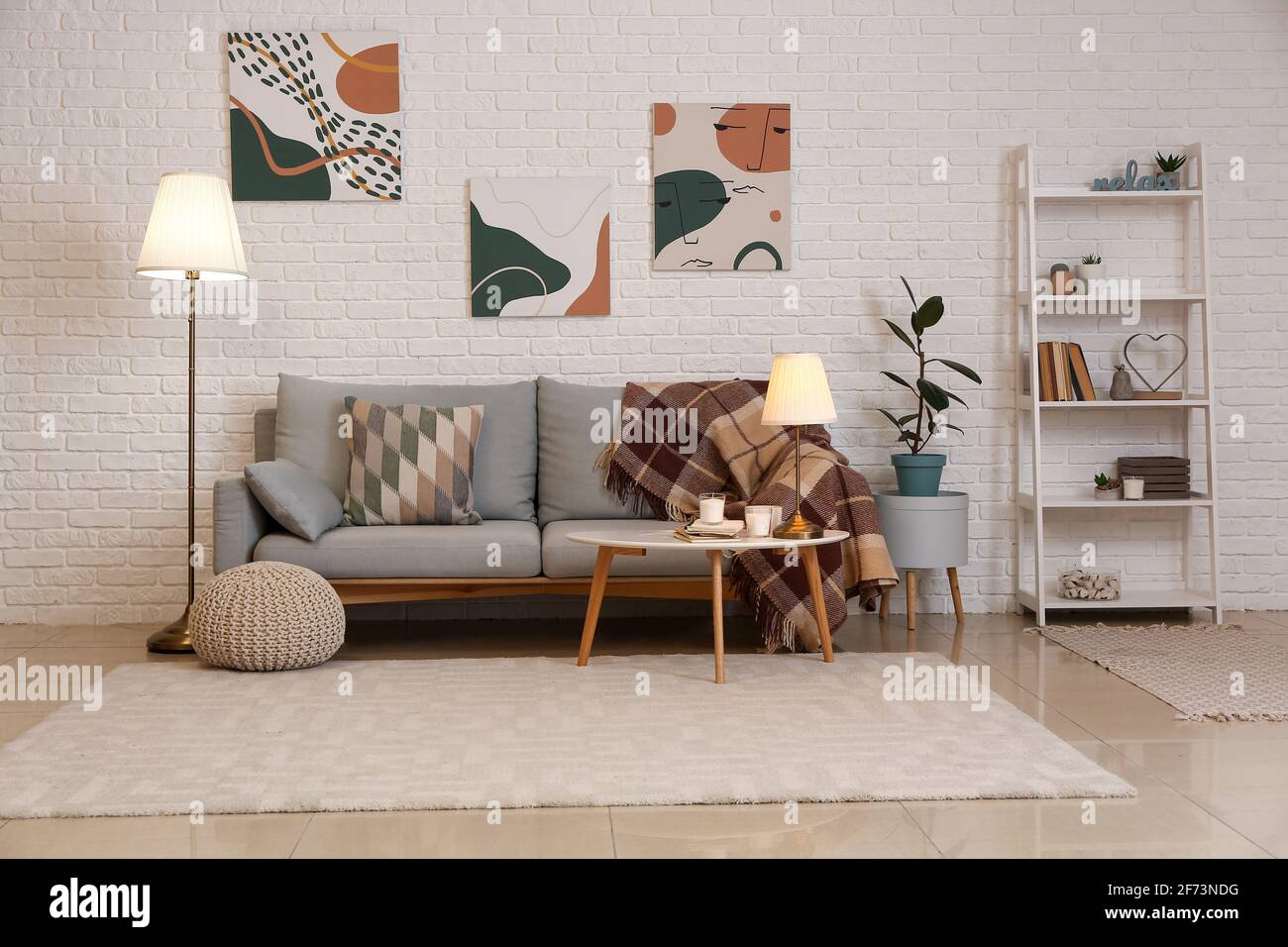 Interior of modern room with sofa and lamps Stock Photo - Alamy