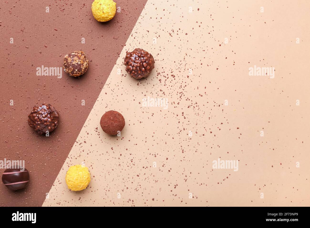 Sweet chocolate candies on color background Stock Photo - Alamy