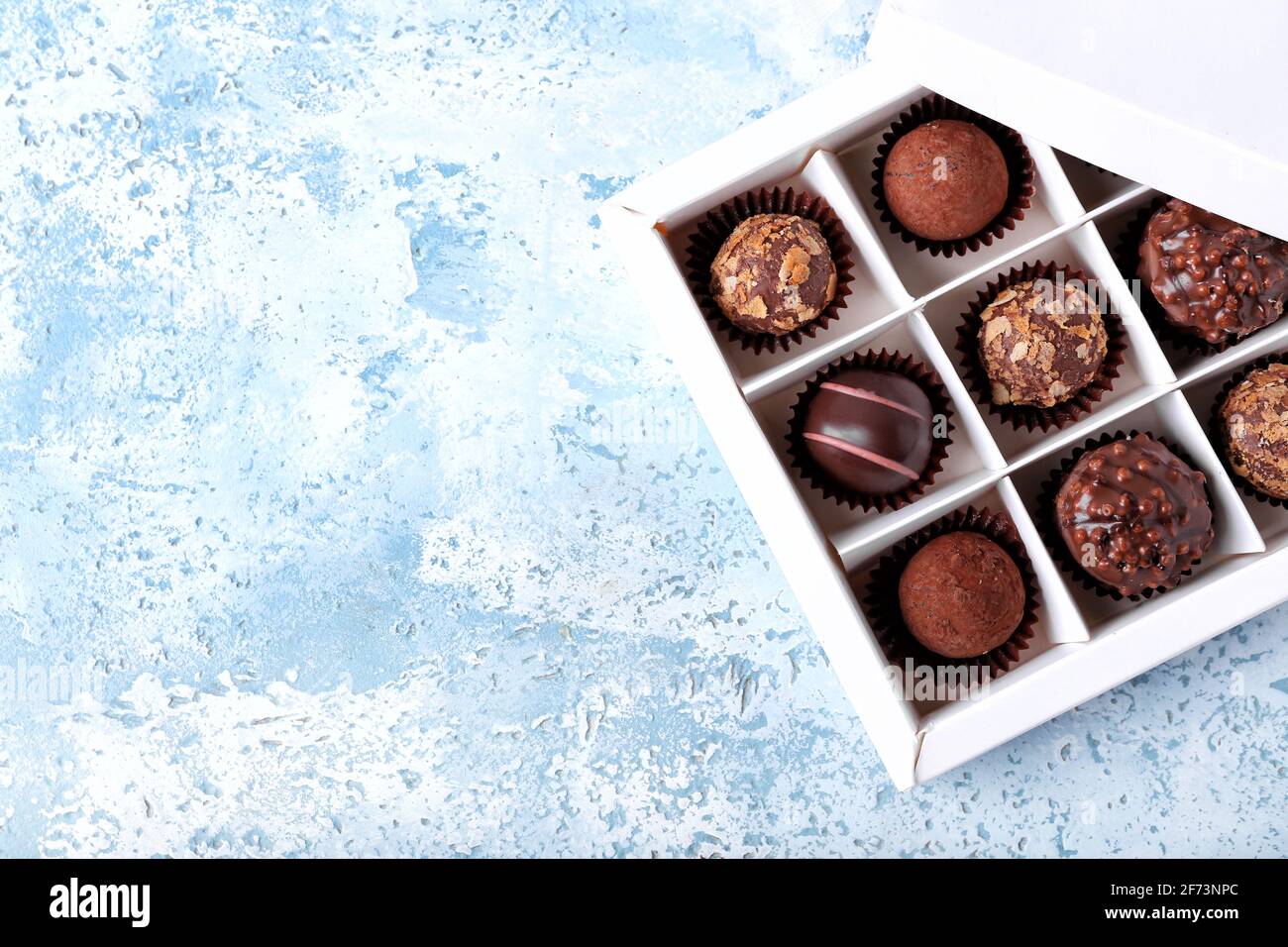 Box with sweet chocolate candies on color background Stock Photo - Alamy