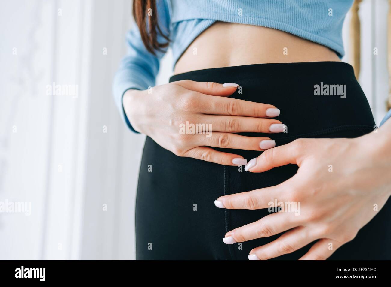 Slim girl touching belly hi-res stock photography and images - Alamy