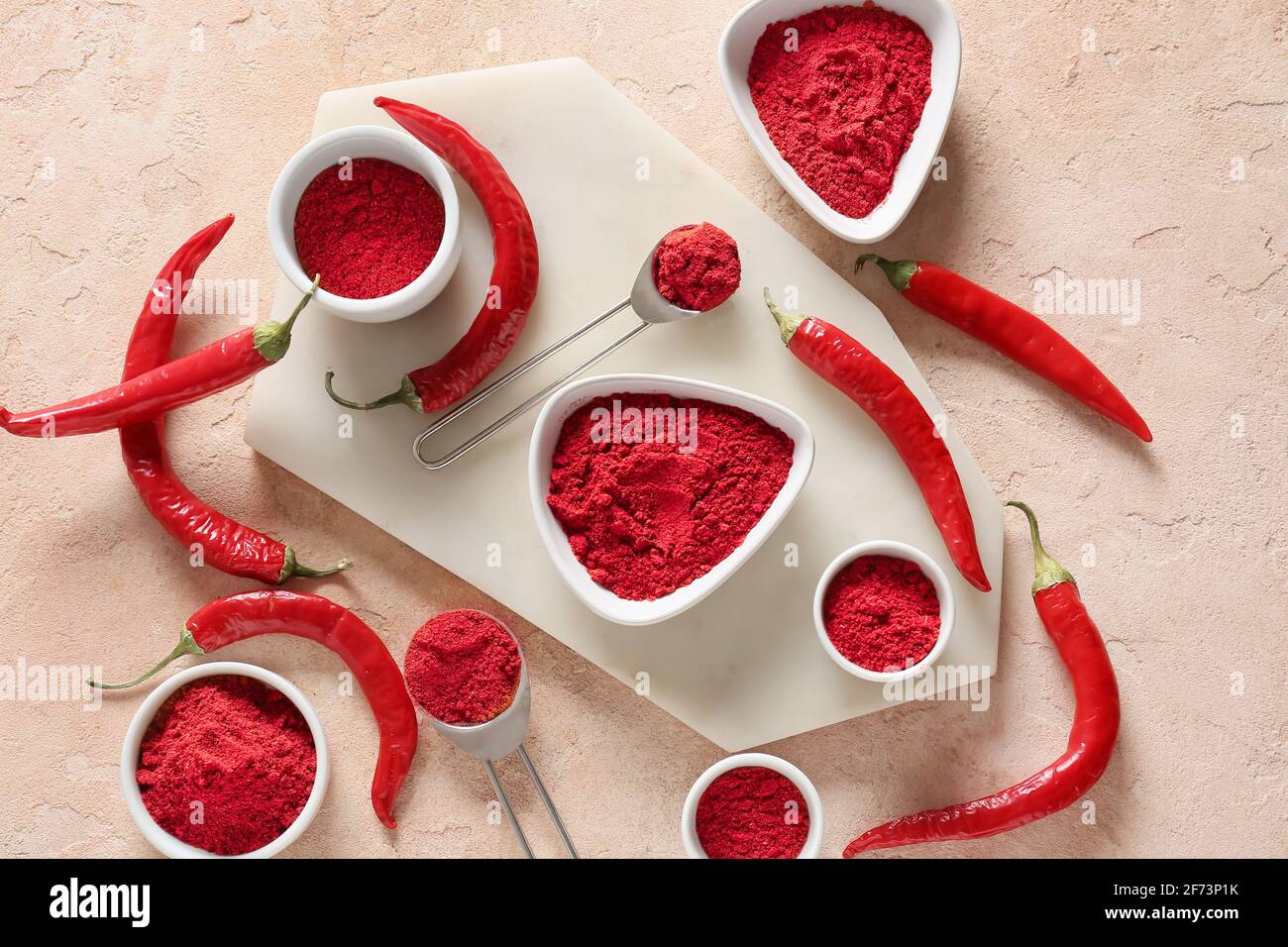 Bowls with red chili powder on color background Stock Photo - Alamy