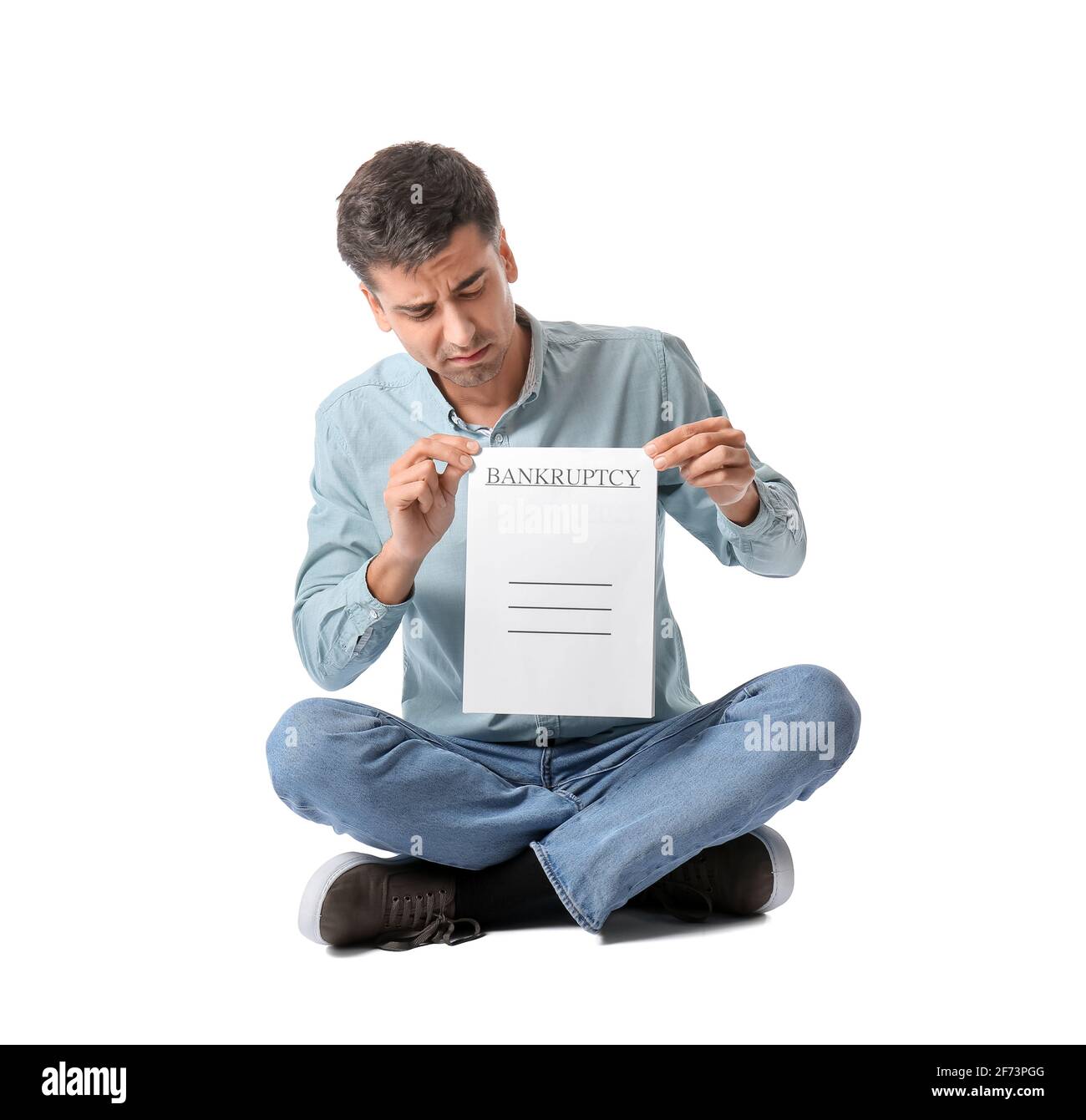 Sad man holding paper with word BANKRUPTCY on white background Stock ...