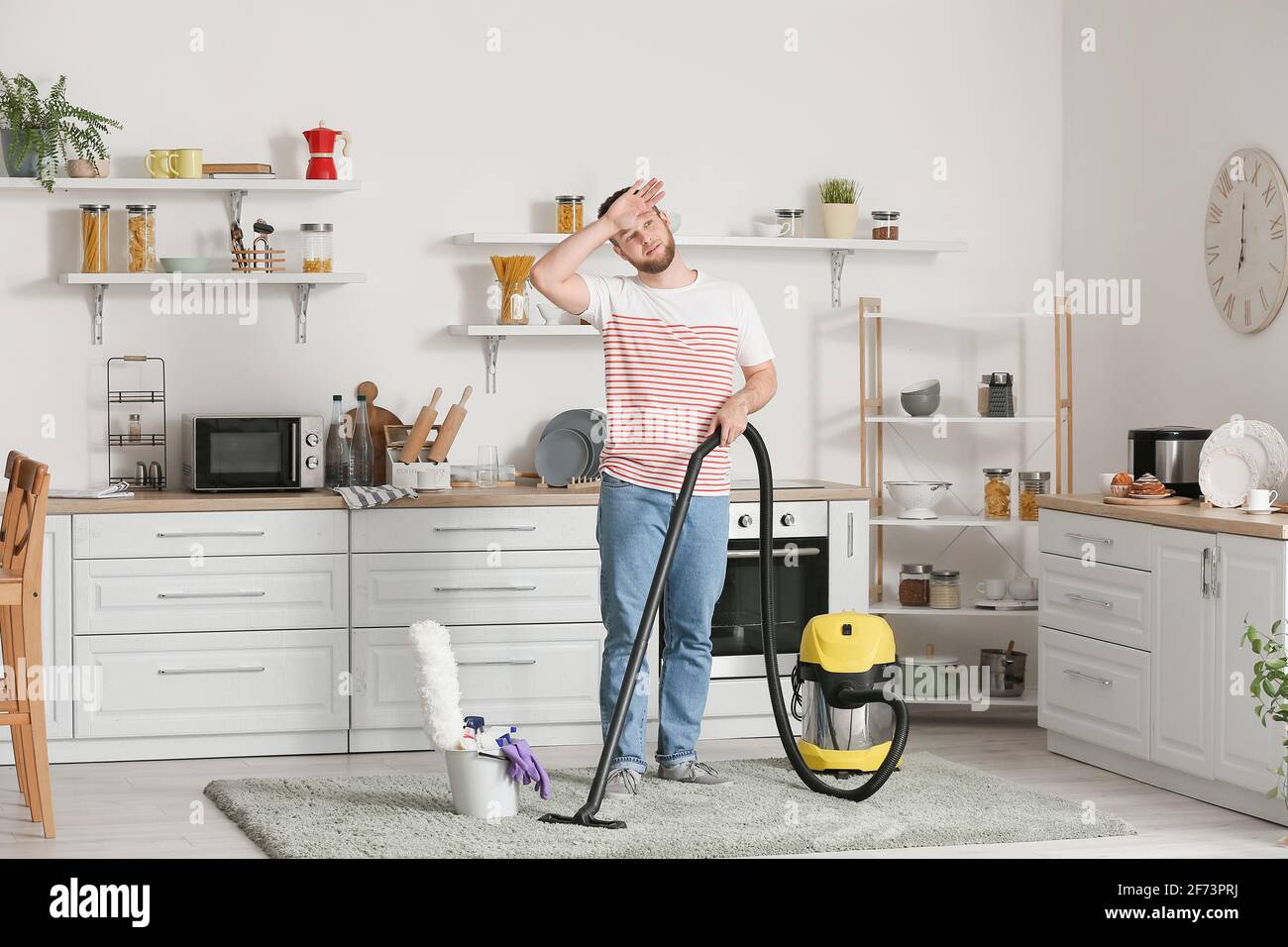 Tired young man hoovering hi-res stock photography and images - Alamy