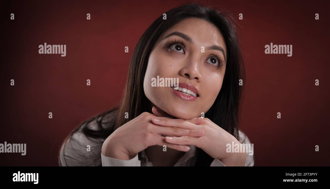 Dreamy facial expression of a young pretty woman Stock Photo - Alamy