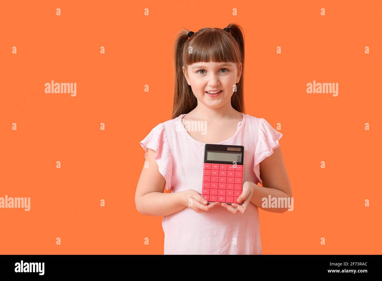 Little girl with calculator on color background Stock Photo - Alamy