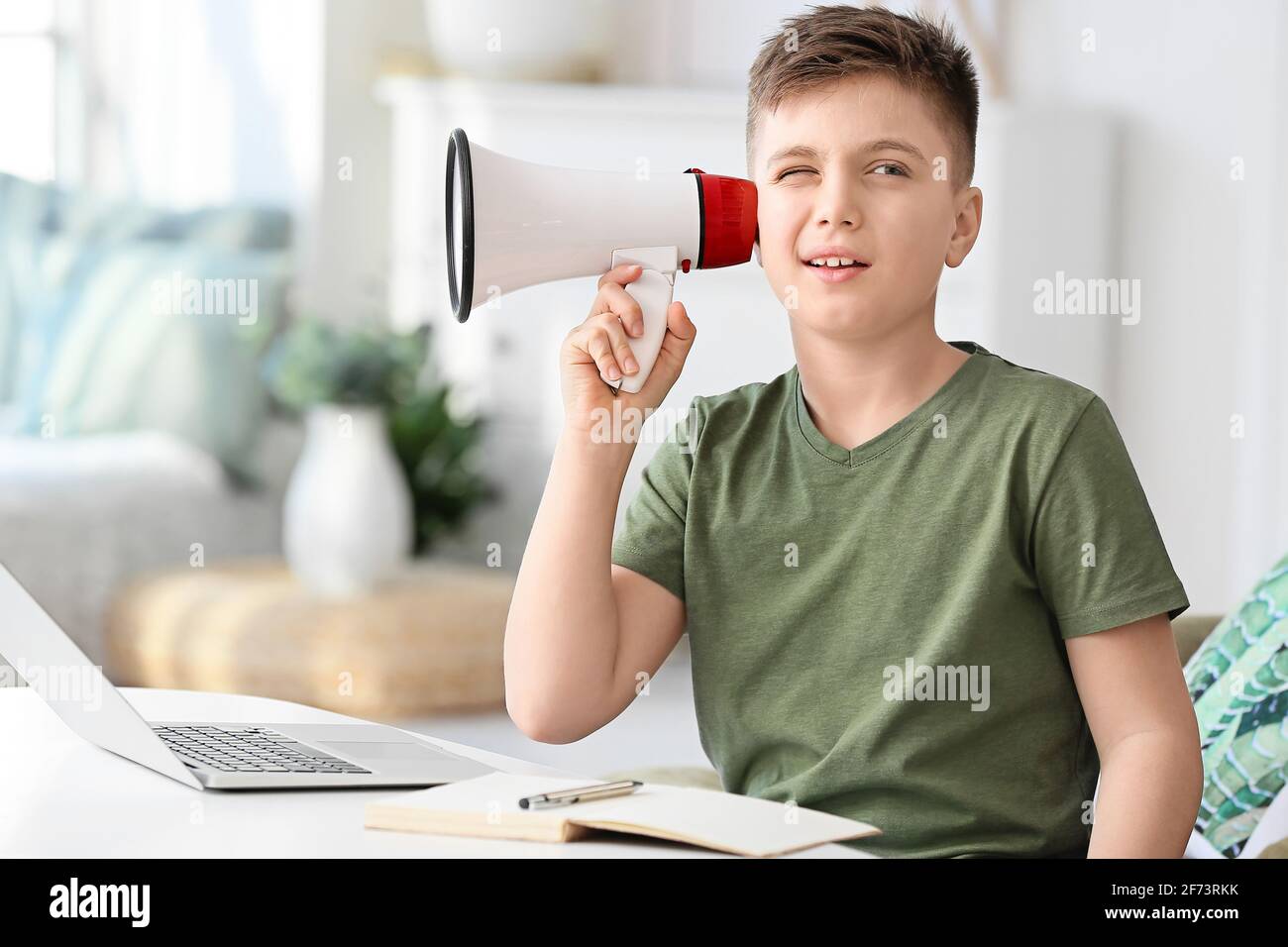 Little boy with megaphone trying to hear something at home Stock Photo ...
