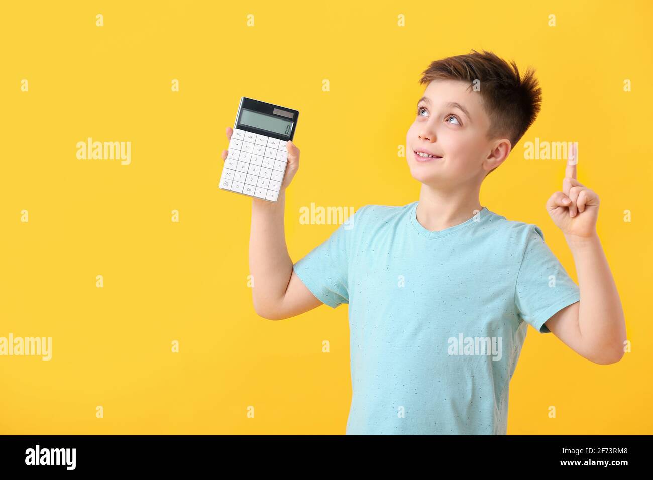 Little boy with calculator showing something on color background Stock ...
