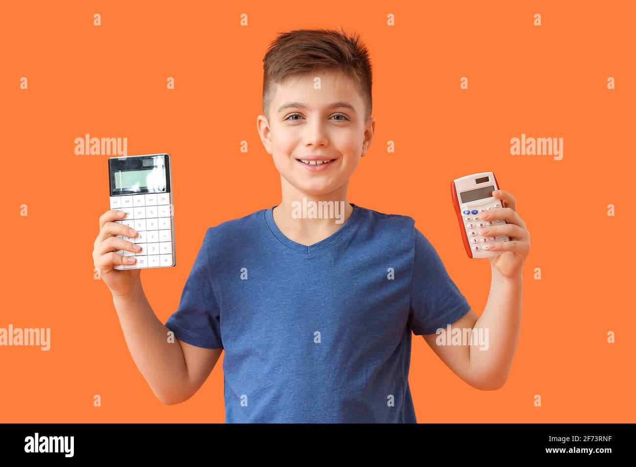 Little boy with calculators on color background Stock Photo - Alamy