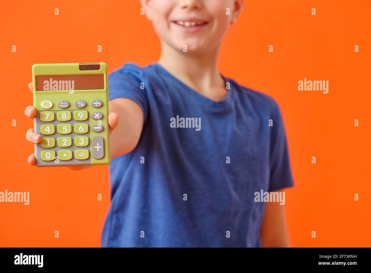 Little boy with calculator on color background Stock Photo - Alamy
