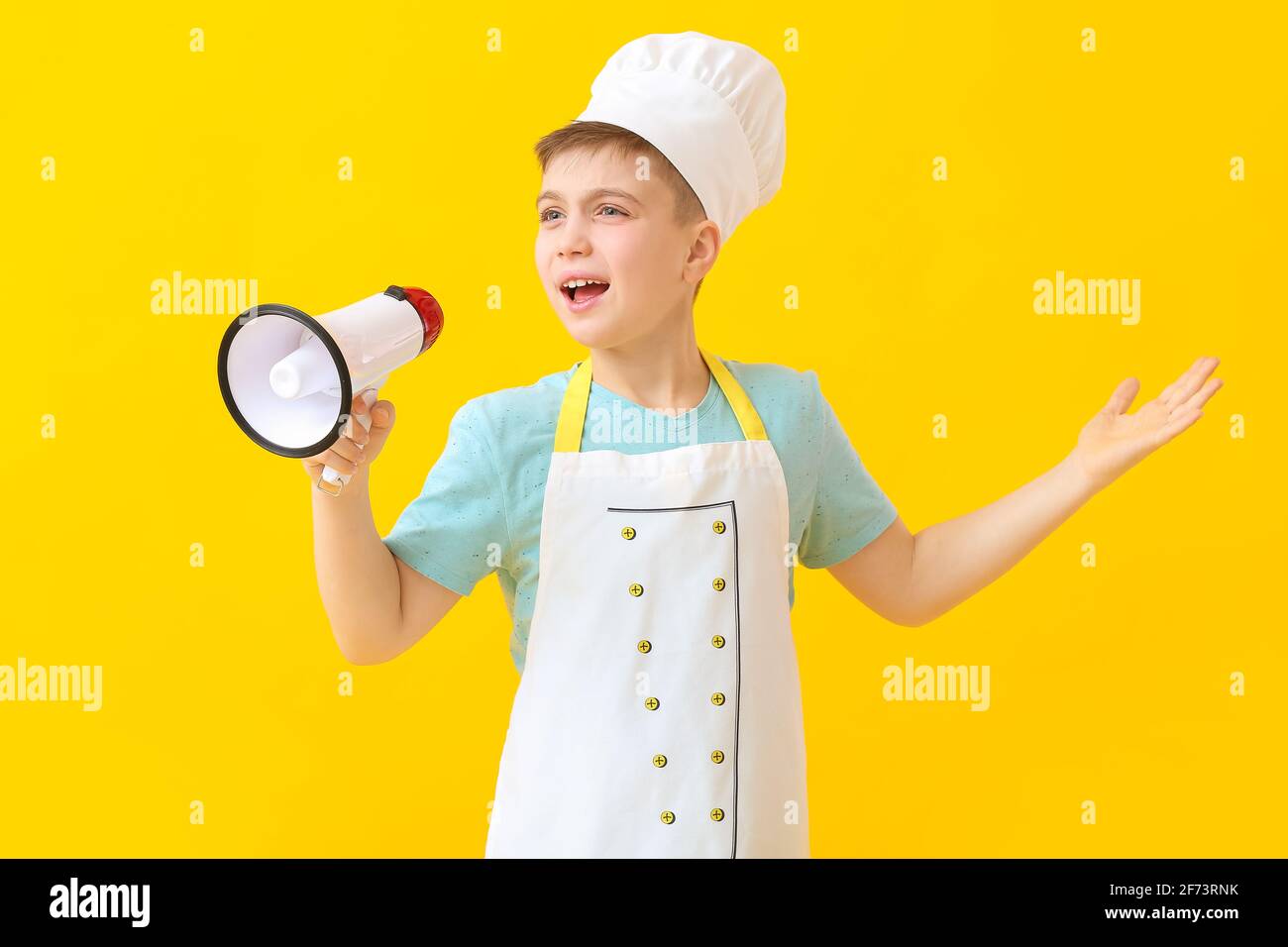 Little chef with megaphone on color background Stock Photo - Alamy