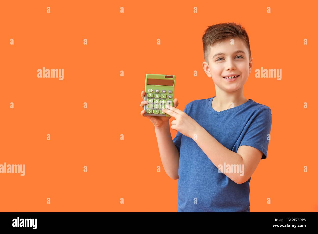 Little boy with calculator on color background Stock Photo - Alamy