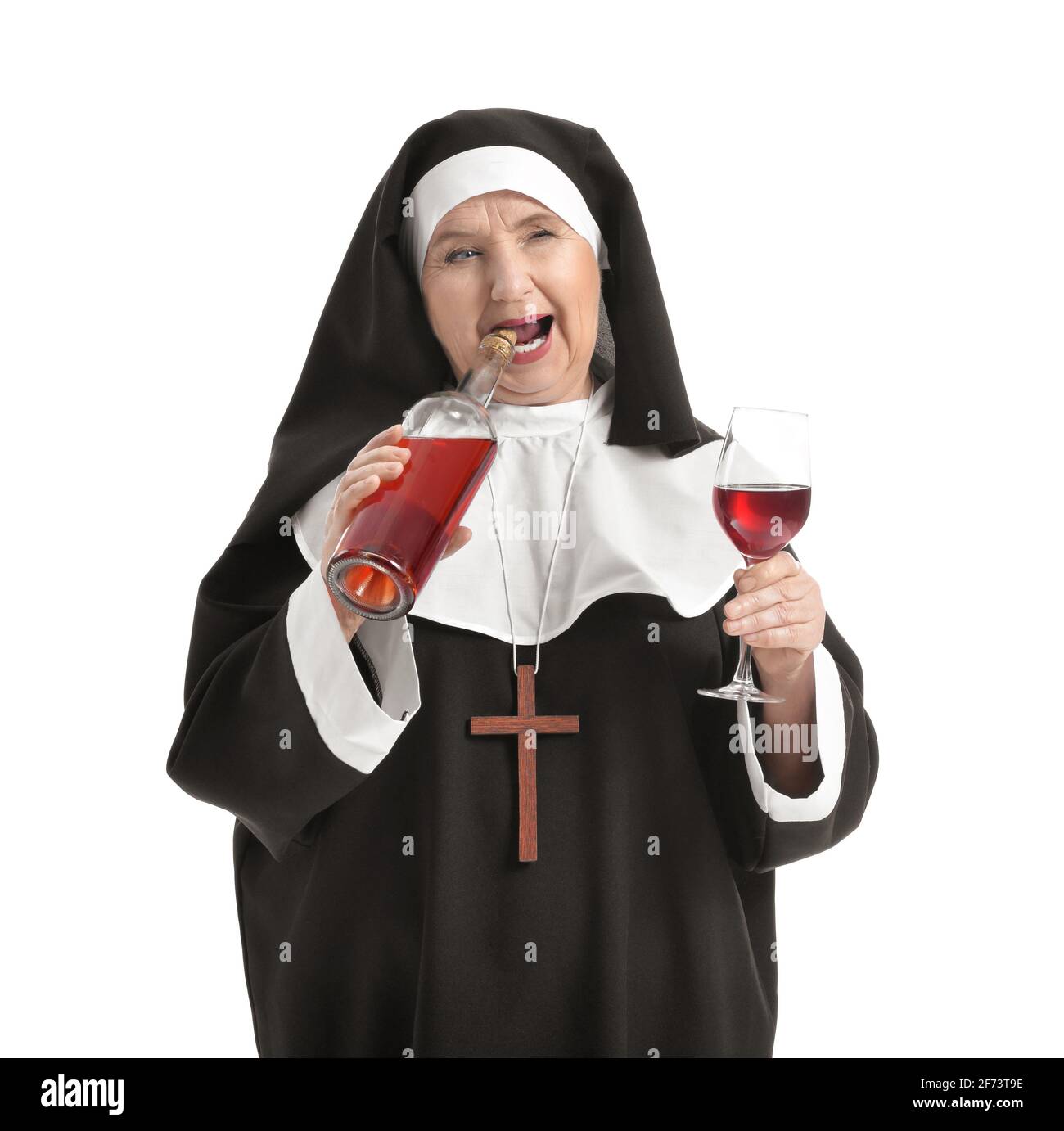 Senior nun with alcohol on white background Stock Photo - Alamy
