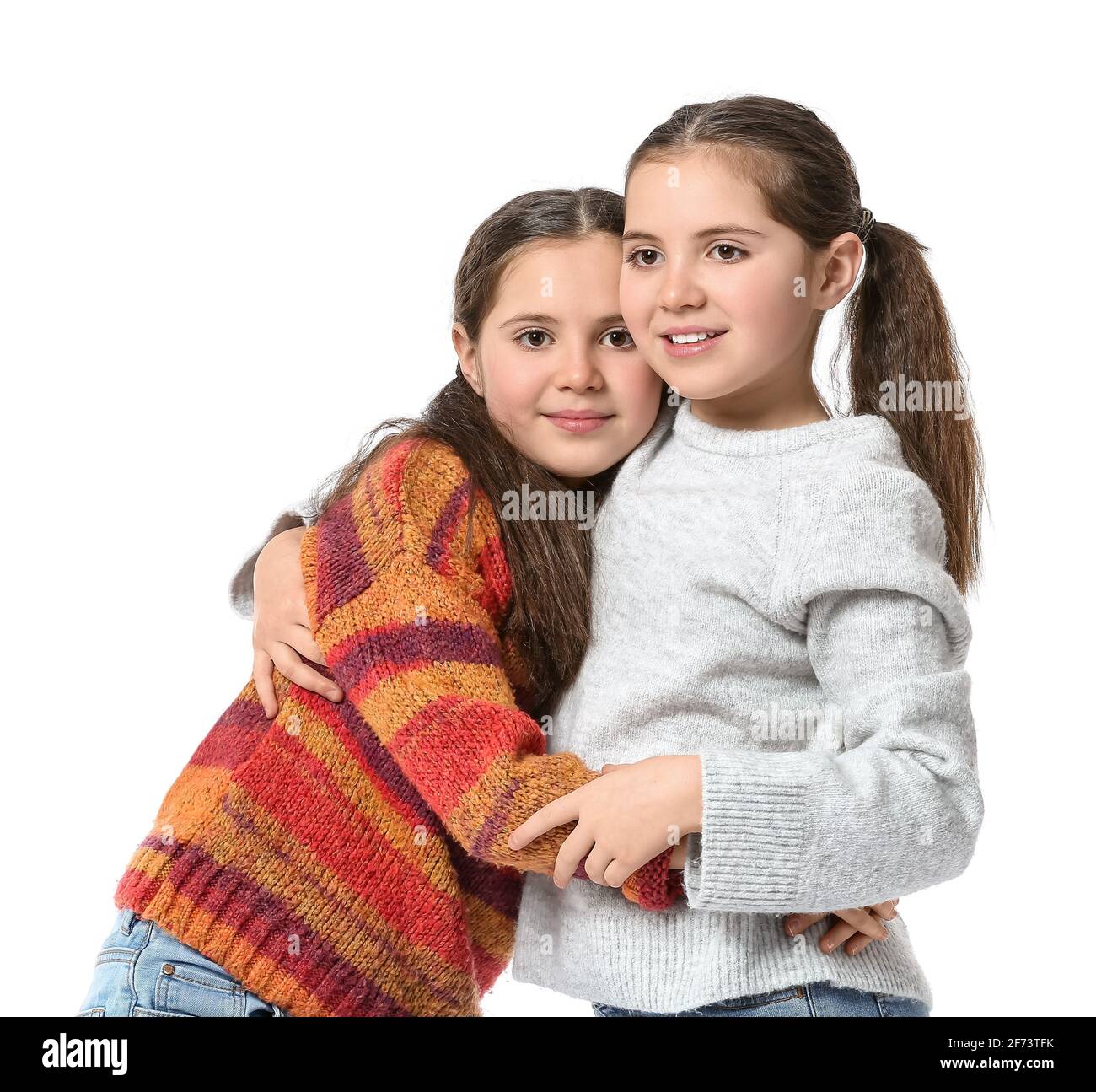 Portrait of cute twin girls on white background Stock Photo - Alamy