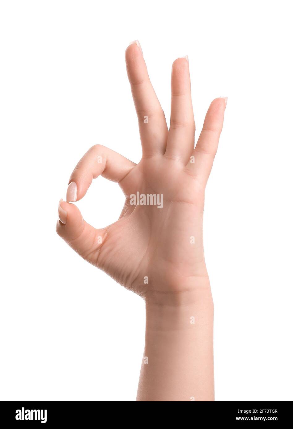 Female hand showing OK gesture on white background Stock Photo - Alamy
