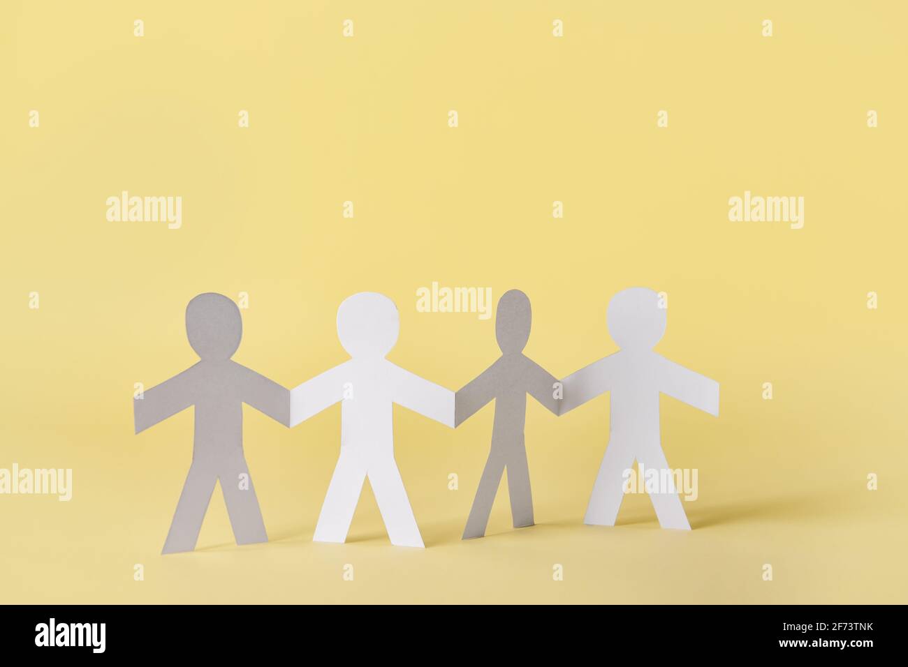 Paper human figures on color background Stock Photo - Alamy
