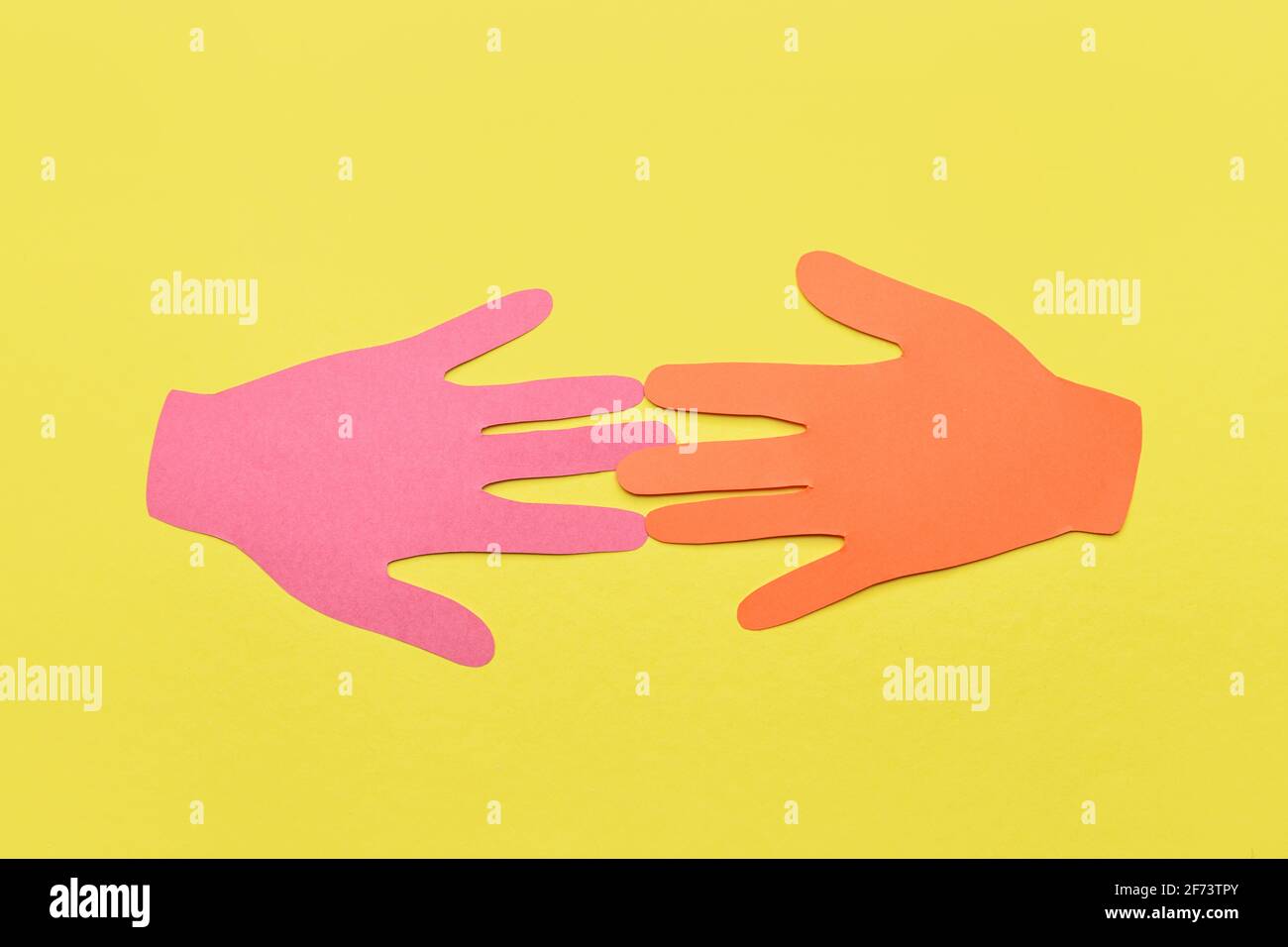 Paper human palms on color background Stock Photo - Alamy