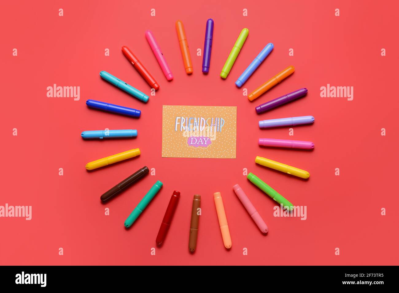 Markers and greeting card for Friendship Day on color background Stock ...