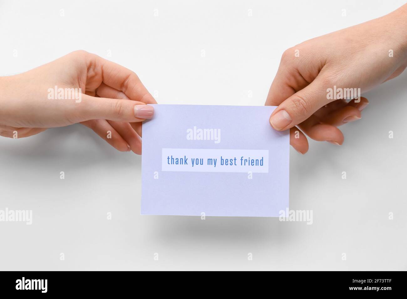 Female hands holding greeting card for Friendship Day on white ...