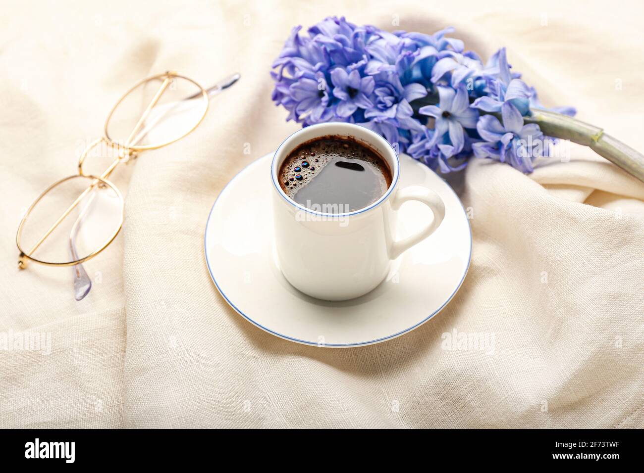 Cup of coffee with spring flowers and eyeglasses on cloth Stock Photo ...