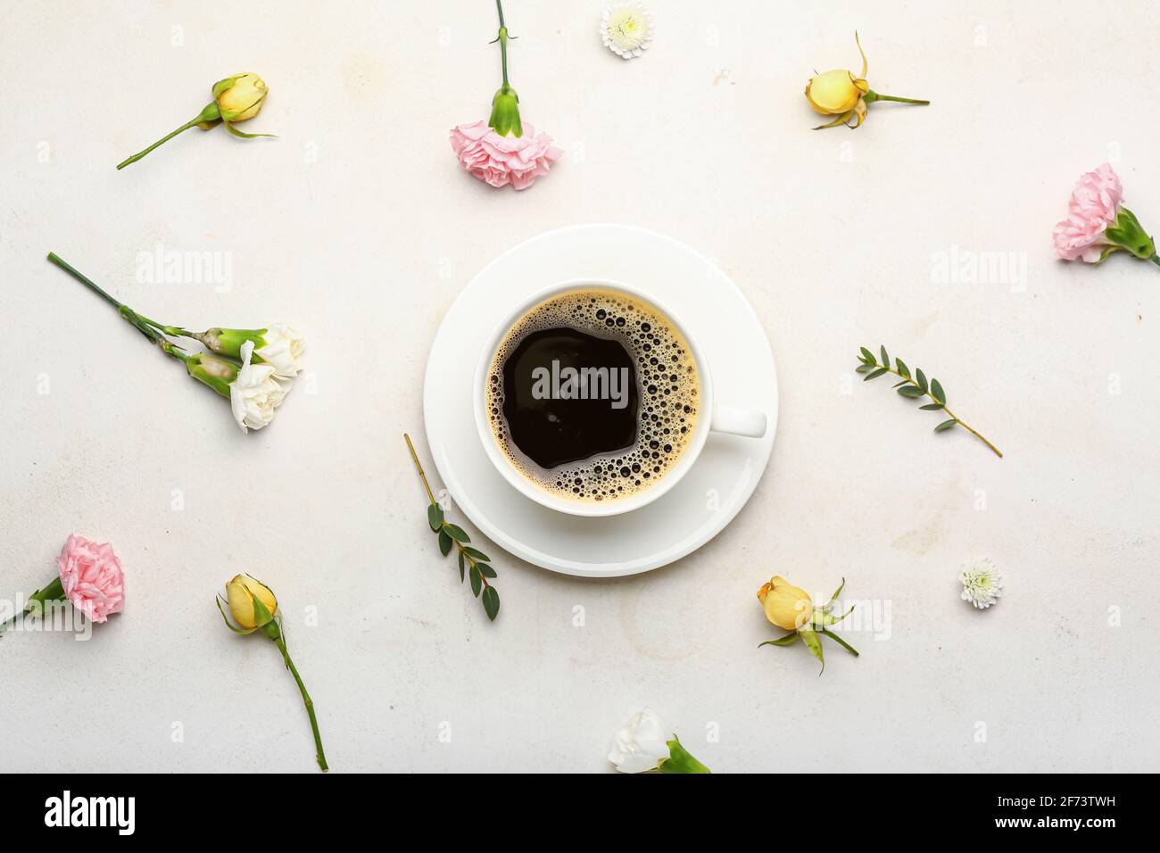 Cup of coffee with spring flowers on light background Stock Photo - Alamy