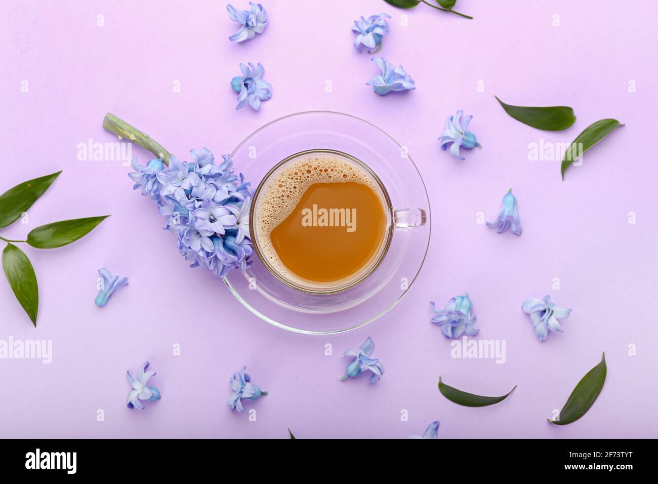 Cup of coffee with spring flowers on color background Stock Photo - Alamy