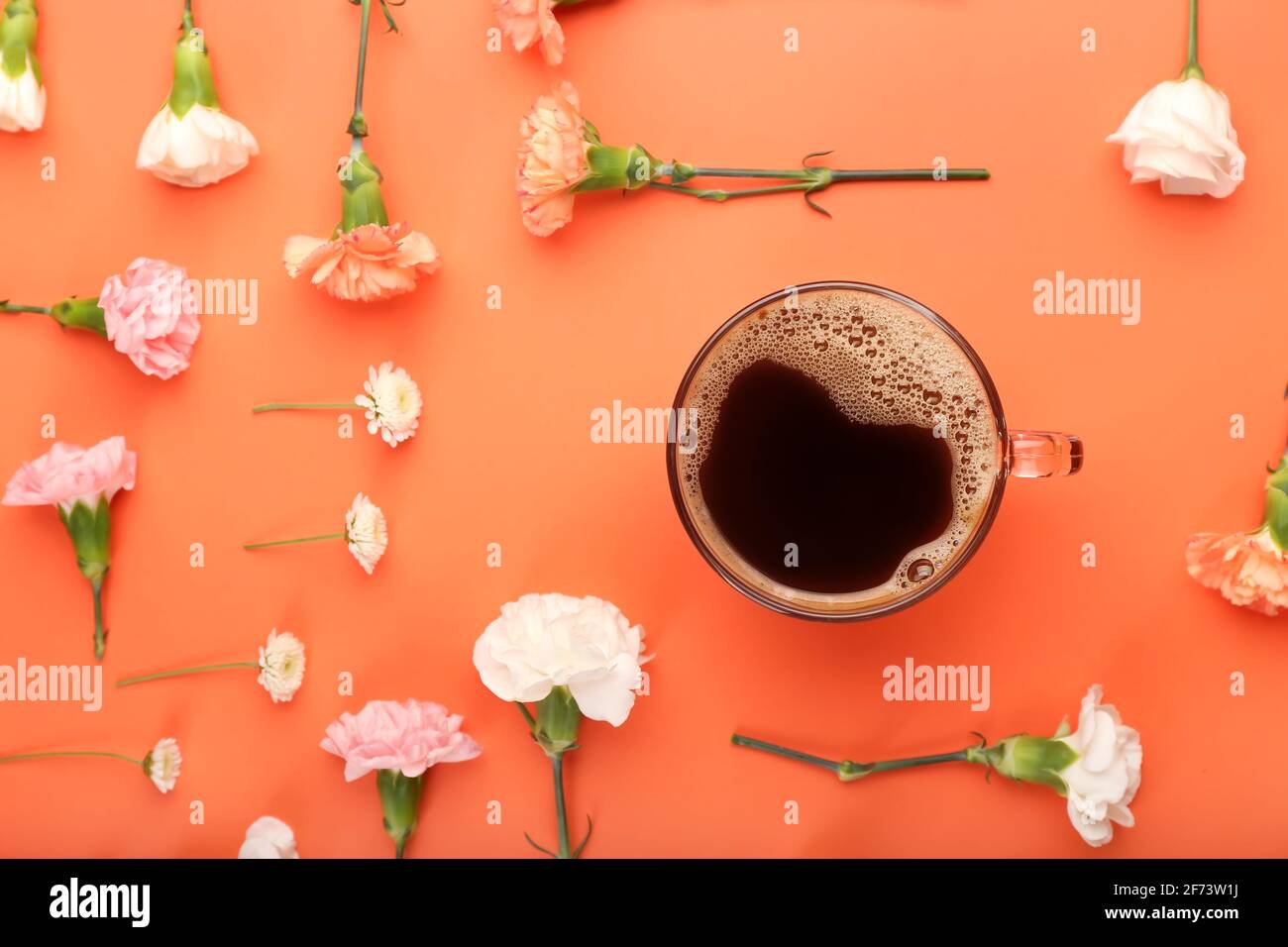 Cup of coffee with spring flowers on color background Stock Photo - Alamy