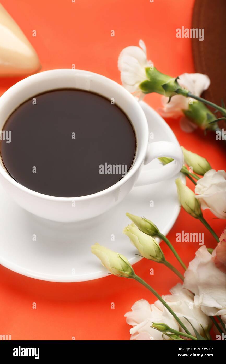 Cup of coffee with spring flowers on color background Stock Photo - Alamy