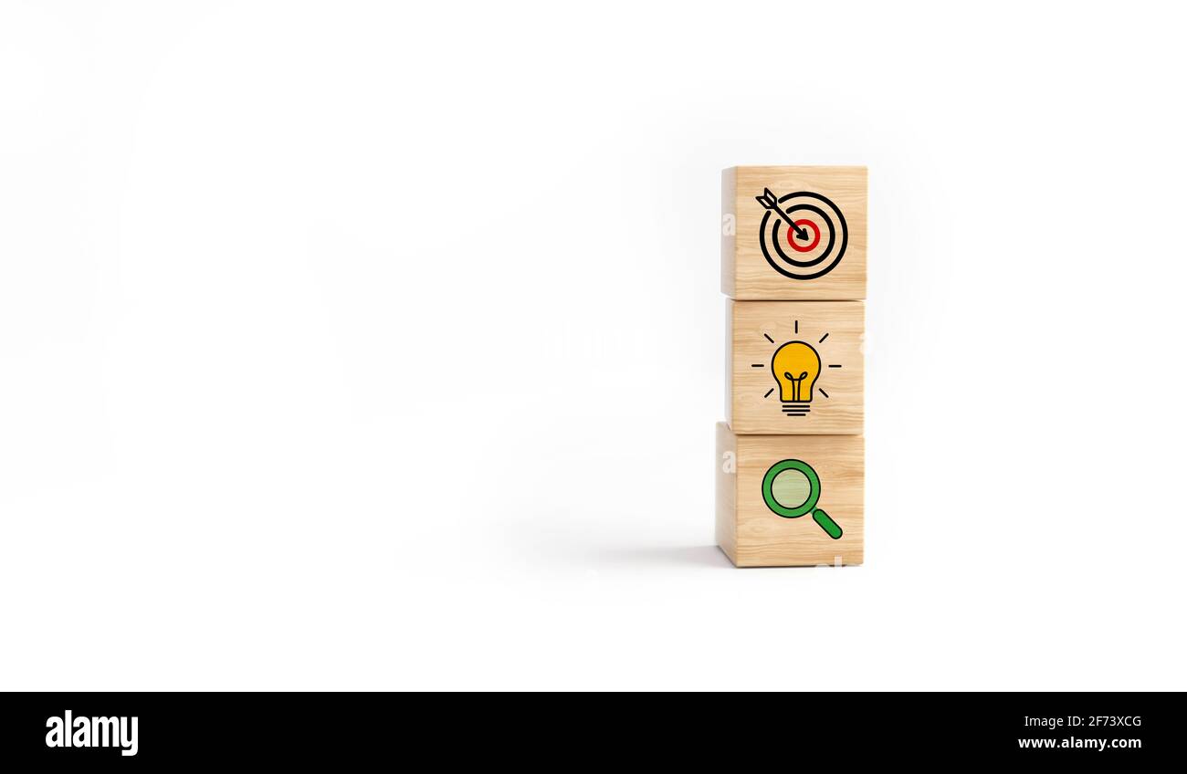 Concept of business strategy and action plan. Wooden cube block with icon target, light bulb and ...