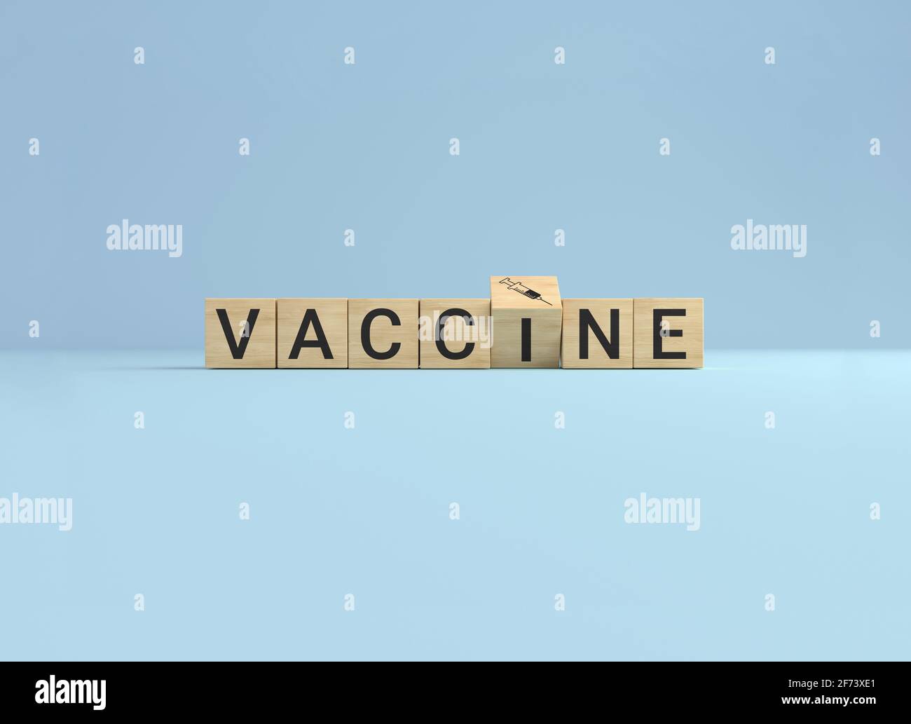 Wooden cube block flip over word vaccine to syringe icon on blue studio ...