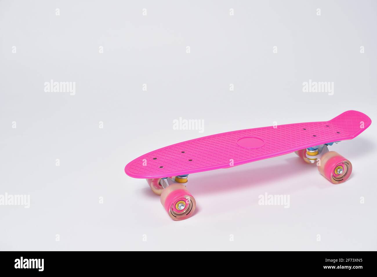 Pink plastic skateboard on white background Stock Photo - Alamy