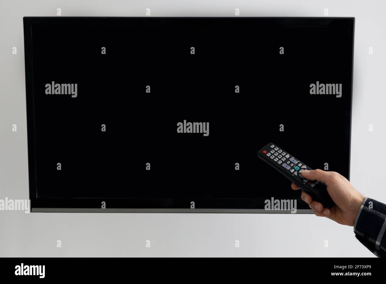 Hand Pointing Remote Control At Empty TV Screen At Home Stock Photo - Alamy