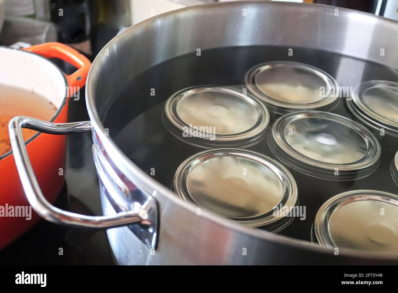 Pickling jars in a pot full of water Stock Photo - Alamy