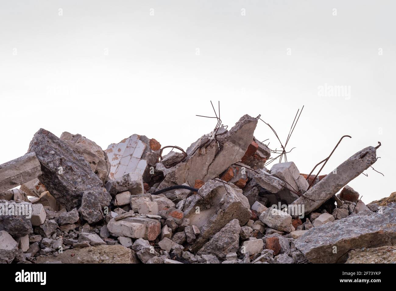 Concrete fragments of a destroyed building close-up with protruding ...