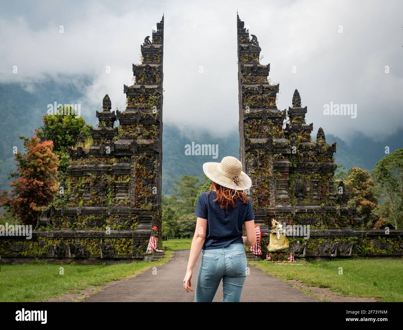 Female traveler at famous gates of Hindu temple in Bali, Indonesia ...