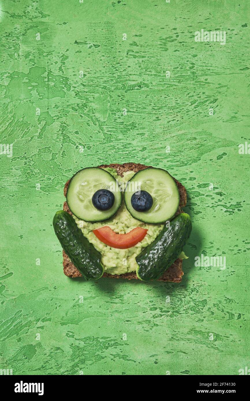 Funny Frog Toast With Cucumber And Mashed Avocado Stock Photo - Alamy