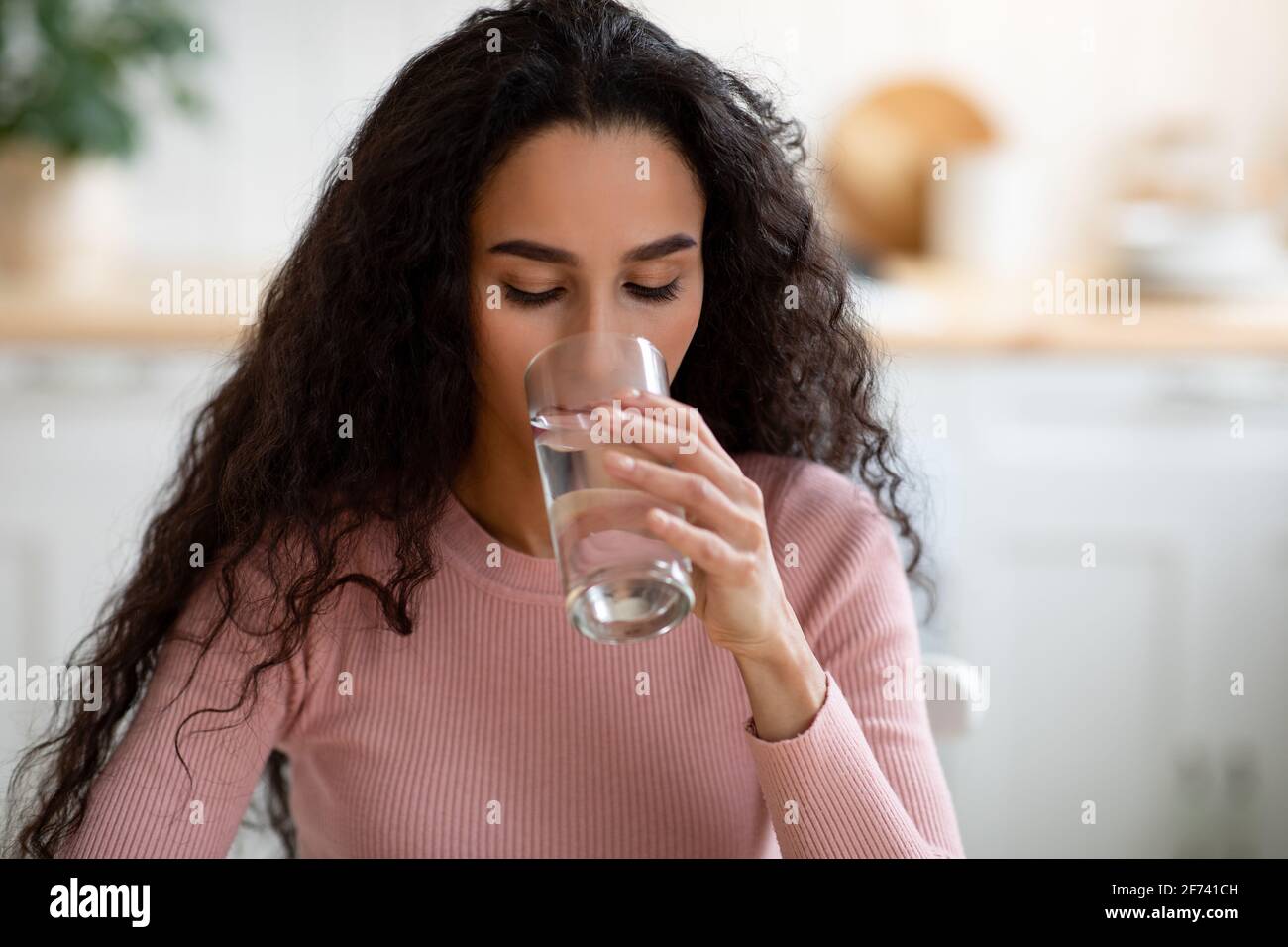 Attractive Millennial Lady Drinking Mineral Water From Glass In Kitchen ...
