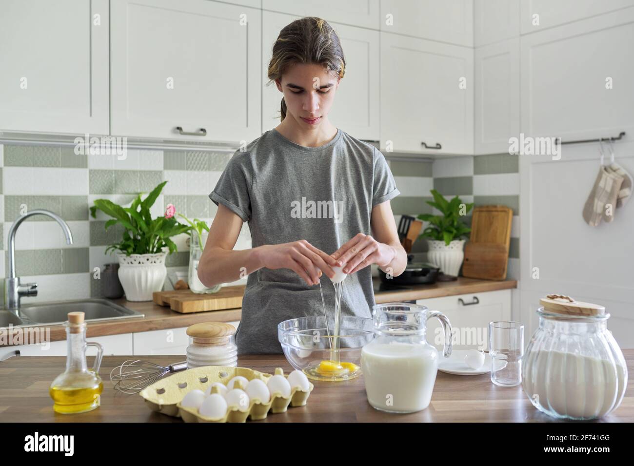 Teen boy cooking in the kitchen hi-res stock photography and images - Alamy