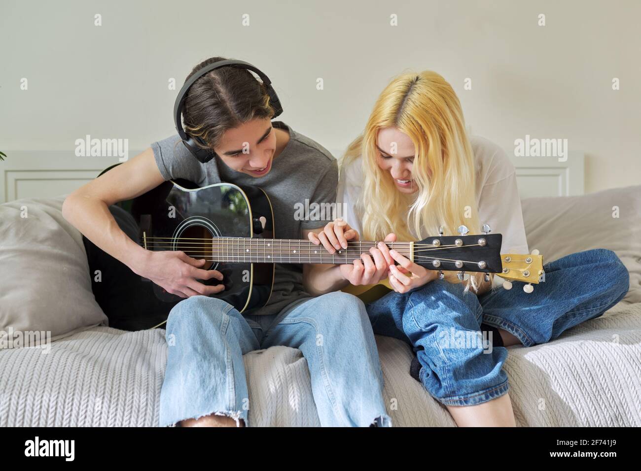 Creative teenagers friends with musical instruments, acoustic guitar ...