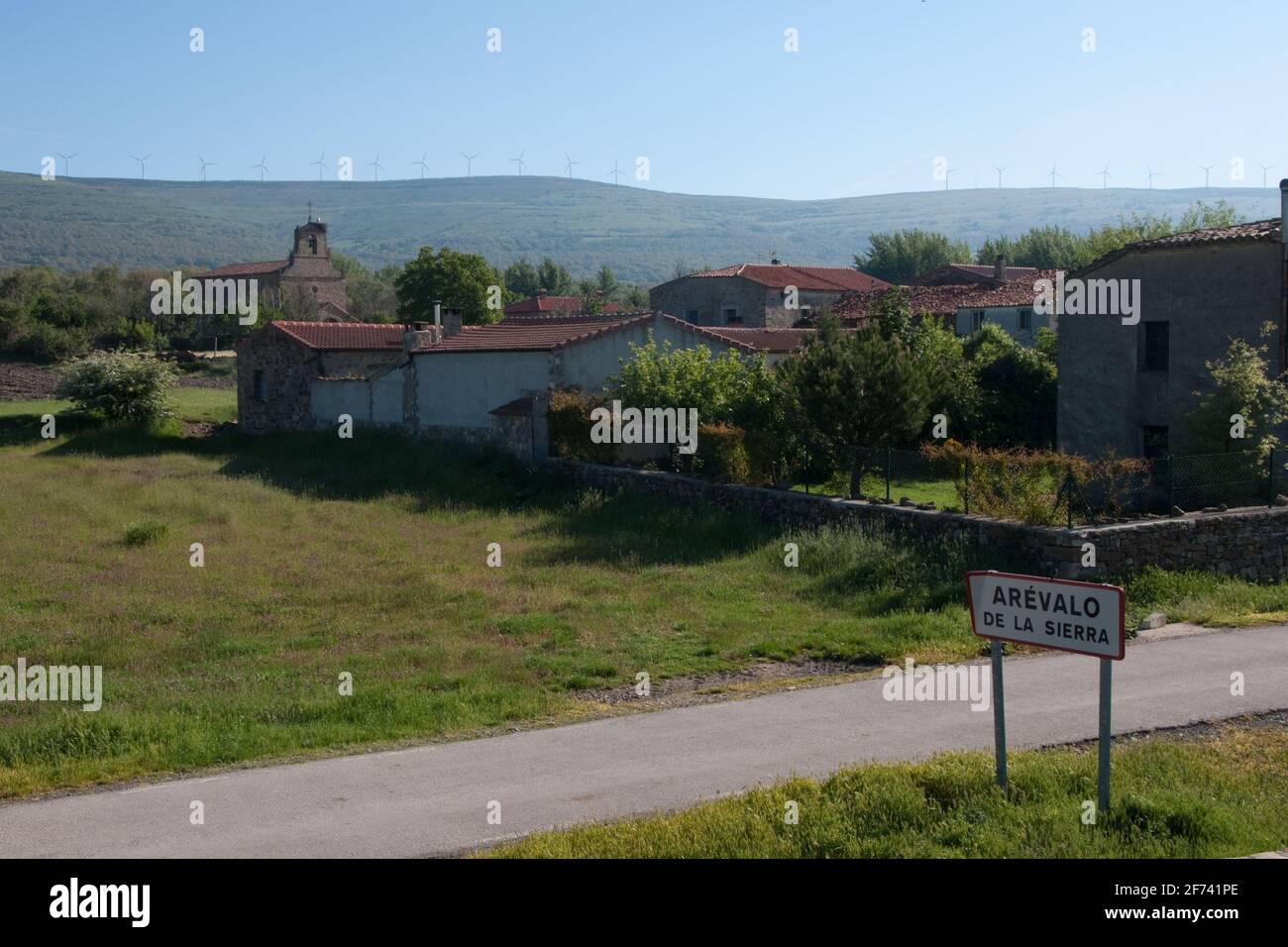 Rural village and countryside in Spain. Wind turbines in the background ...