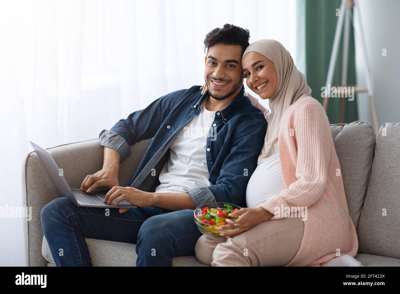 Pregnant Couple's Leisure. Happy Expectant Islamic Spouses Relaxing In ...