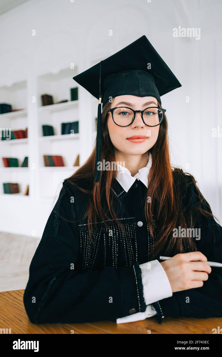 Portrait of confident young caucasian woman student in library ...