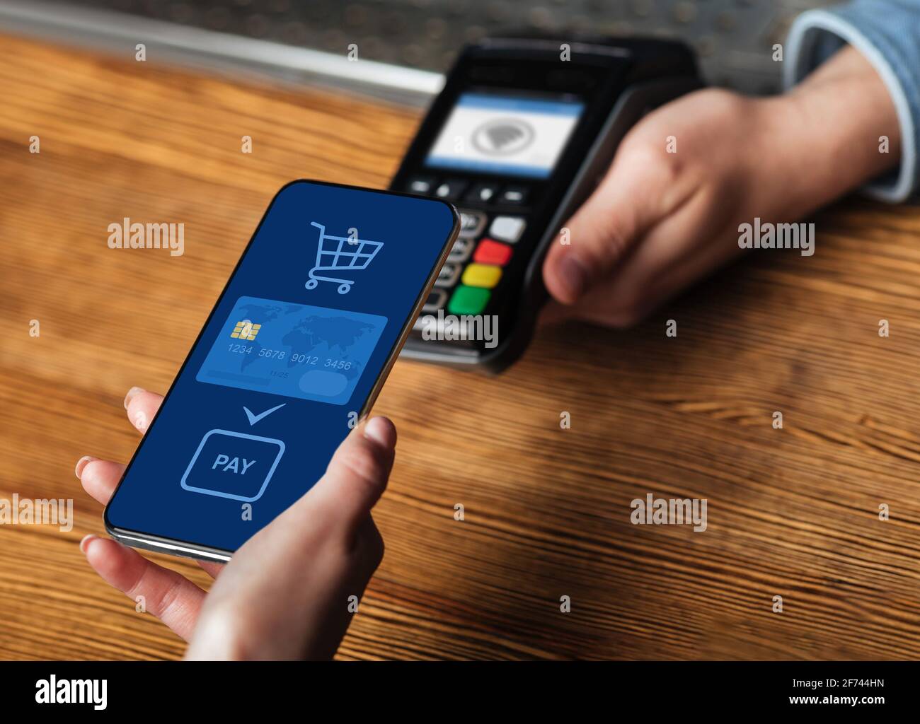 Hands of woman client holding phone over terminal Stock Photo - Alamy