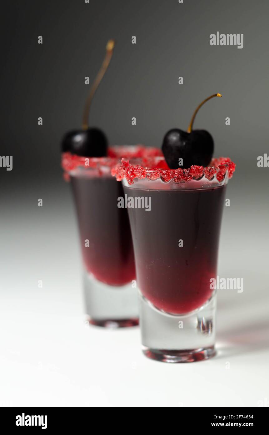 Ruby red cocktail based on vodka, cherry liqueur and syrup in drink ...