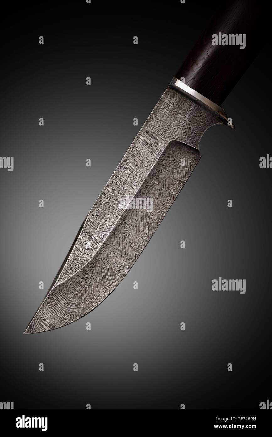 Knife of Damascus steel. Patterned blade close-up Stock Photo - Alamy