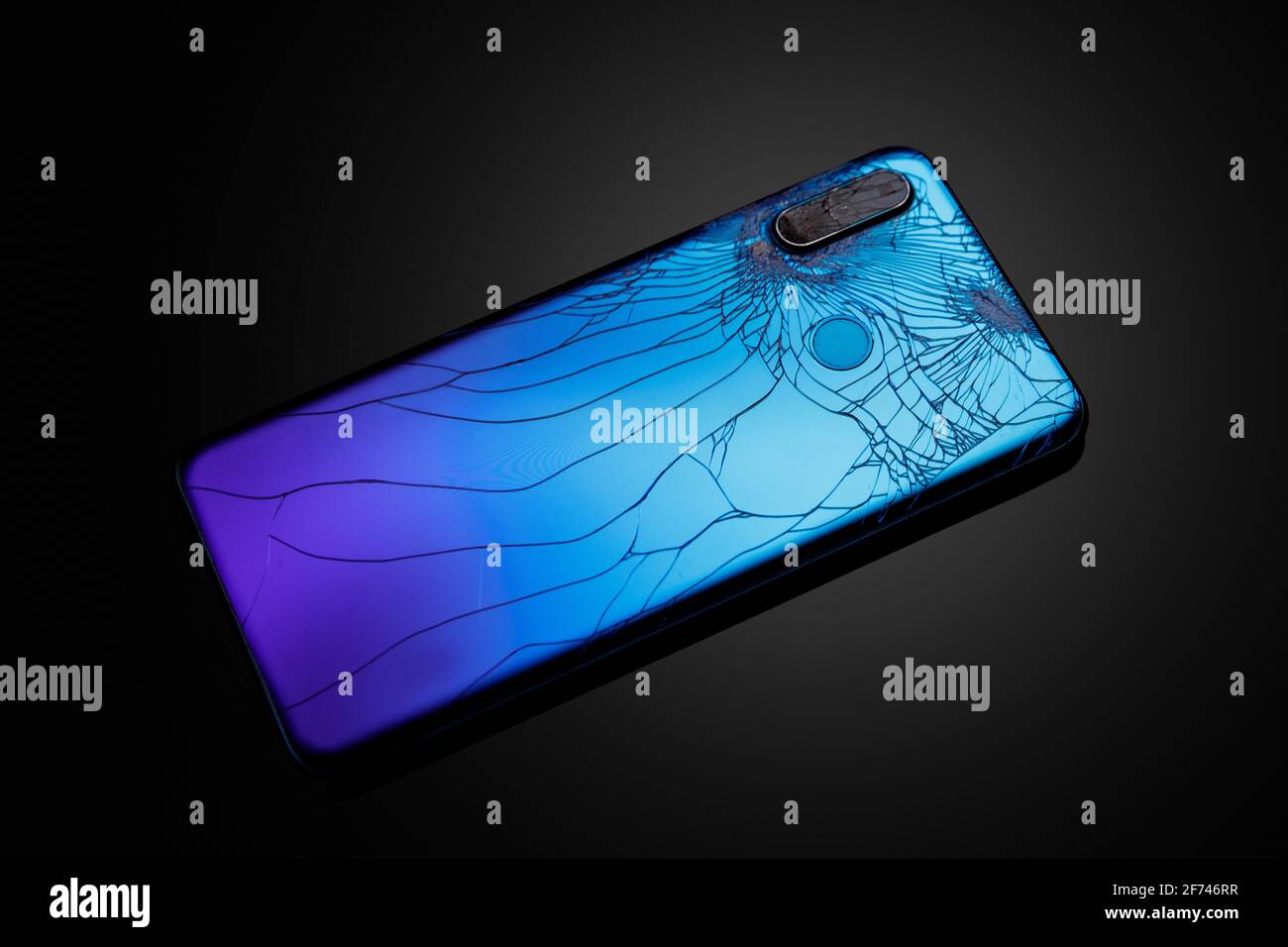 The back side of a broken phone. Spoiled smartphone camera Stock Photo ...